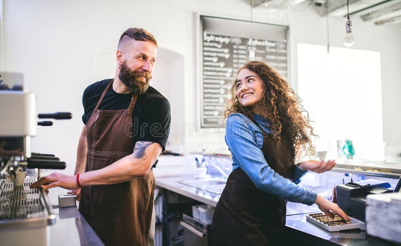 Two Young Baristas Working in Coffee Shop, Standing by Counter ...