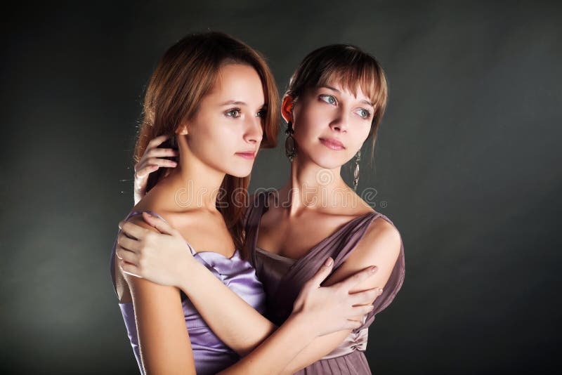 Beauty. Two Women Together at Home on Bed Wearing Lingerie Looking ...