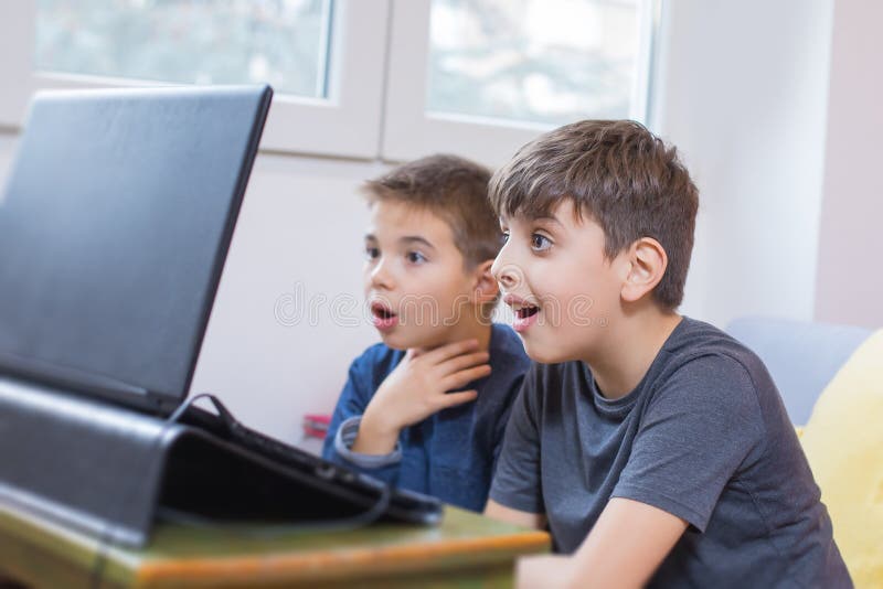 Two Young Boys Enjoying Using Internet on Laptop Stock Image - Image of ...