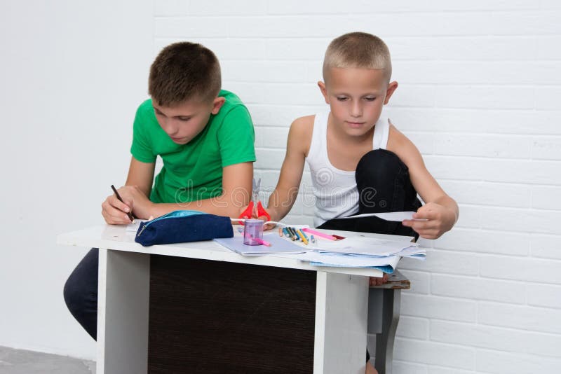 Two Young Boys Focused on Drawing and Creating Art at a Table ...
