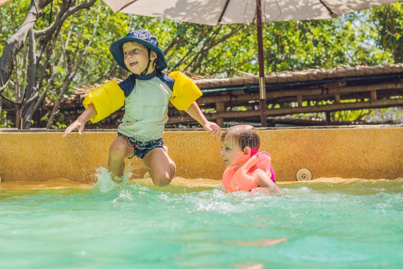 Two Young Boys Friends Jumping in the Pool Stock Image - Image of hair ...