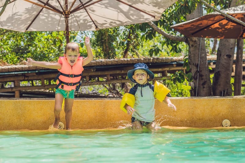 Two Young Boys Friends Jumping in the Pool Stock Image - Image of baby ...