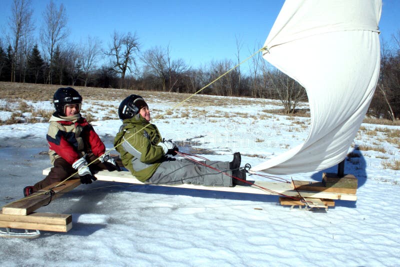 Two Young Boys on Ice Boat with Sails Stock Image - Image of skates ...
