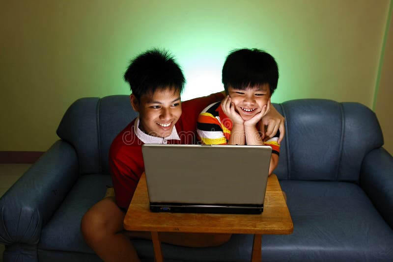 Two Young Boys Using a Laptop Computer and Smiling Stock Image - Image ...