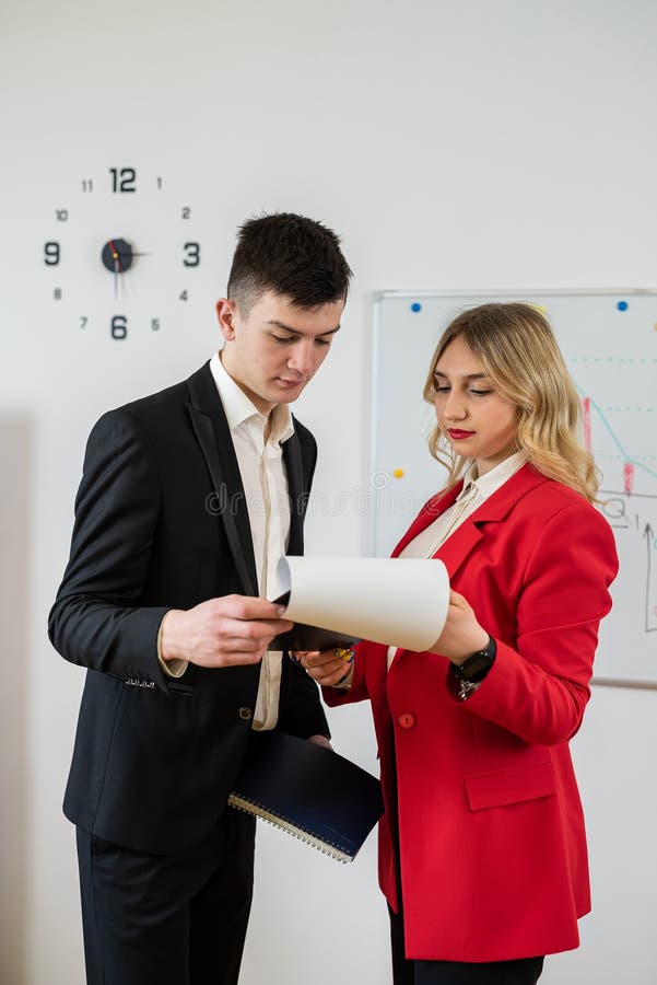 Two Young Business Colleague Discussing with Documents at Office Stock ...