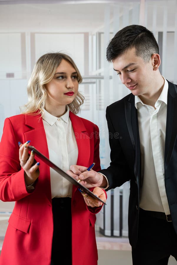 Two Young Business Colleague Discussing with Documents at Office Stock ...