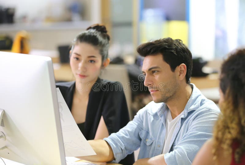 Two Young Business Colleagues Working on Computer, Working Together on ...