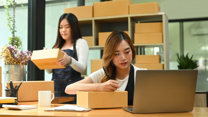 Two Young Business Partner Using Laptop for Checking or Accepting ...