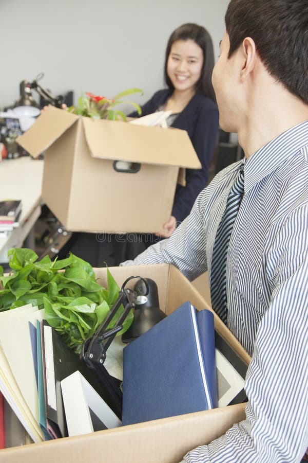 Two Young Business People Carrying Boxes with Office Items Stock Image ...