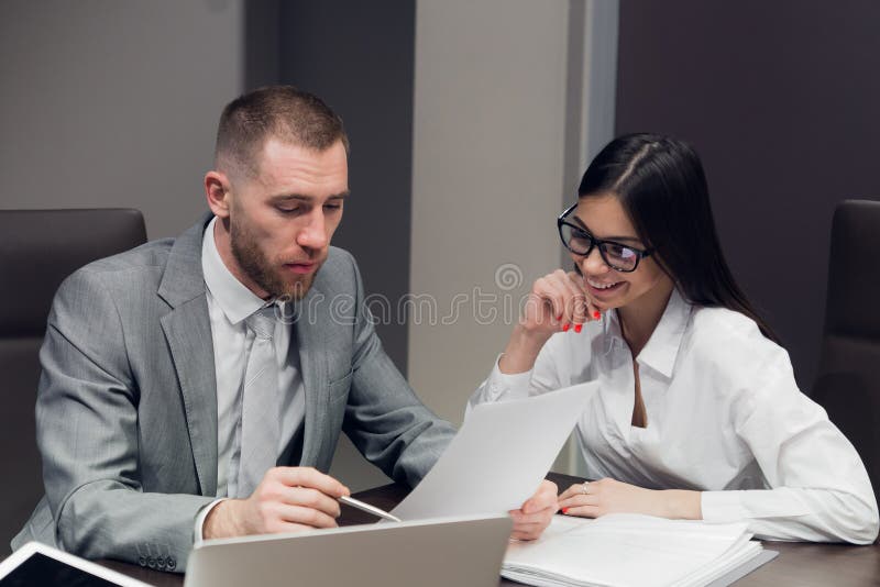 Two Young Business People Discussing Work during a Business ...