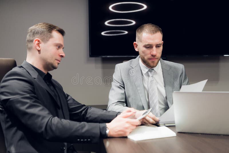 Two Young Business People Discussing Work during a Business ...