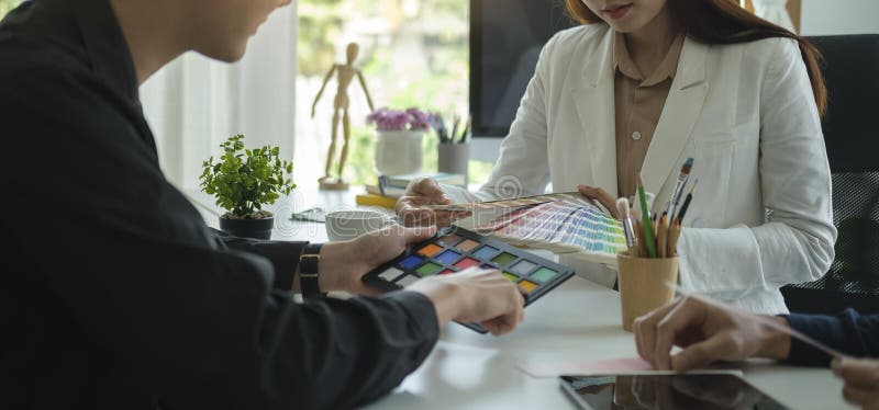 Two Young Business People Sitting in Modern Office and Discussing ...