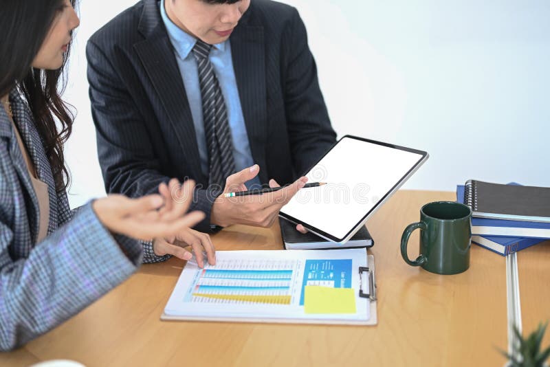 Two Business People Using Digital Tablet and Discussing about Business ...