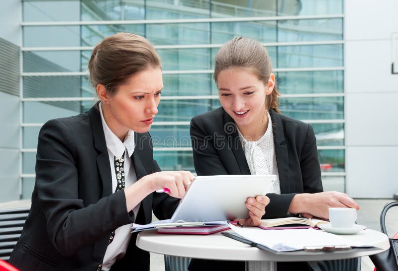 Two young business women stock photo. Image of team, table - 60490886