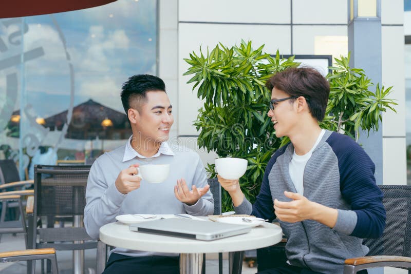Two Young Businessmen are Chatting in a Coffee Shop. - Image Stock ...