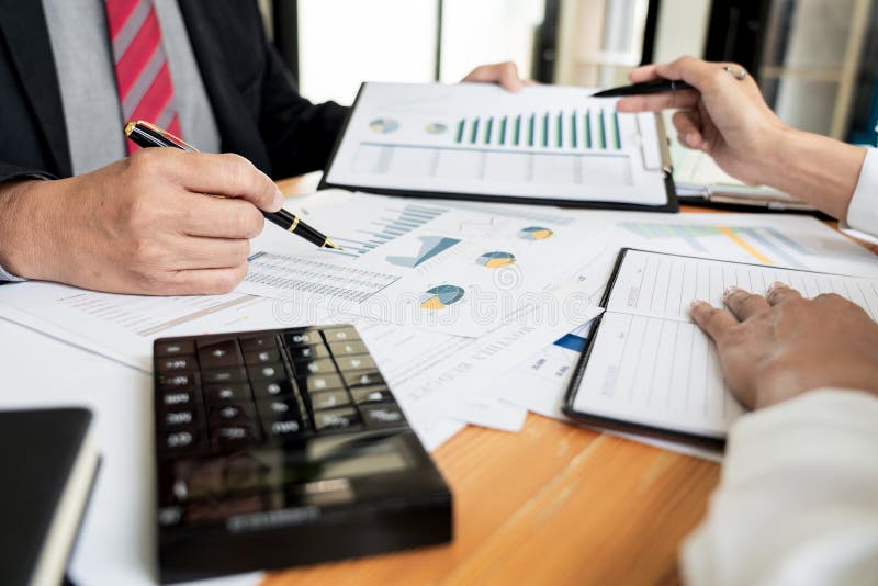Two Young Businessmen Partner Explaining Information and Pointing at ...