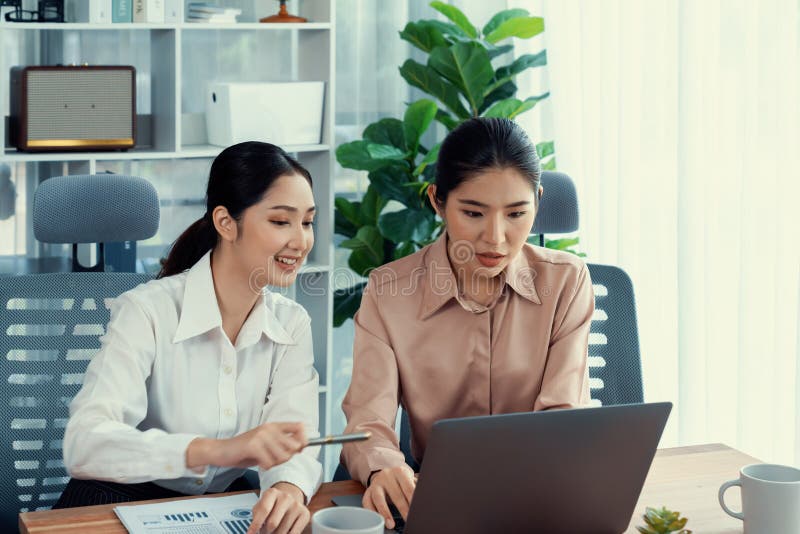 Two Young Businesswoman Work Together In Office Workspace Enthusiastic