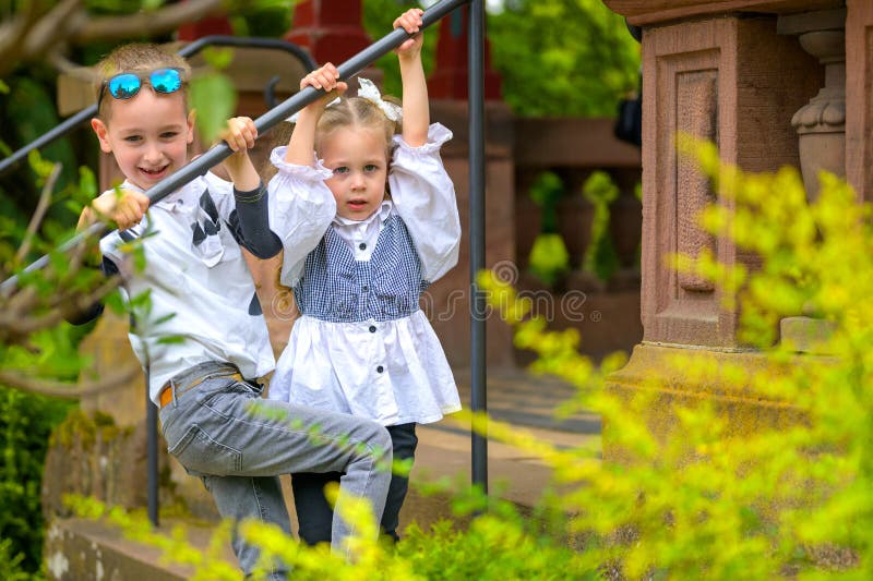 Two Children Playing on Steps Outdoors Stock Photo - Image of ...