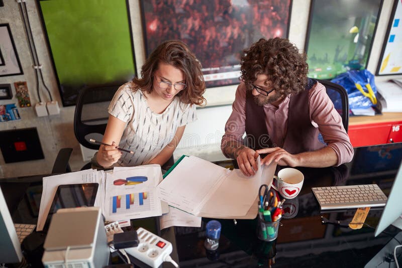 Two Young Colleagues Doing Paperwork Together Stock Photo - Image of ...