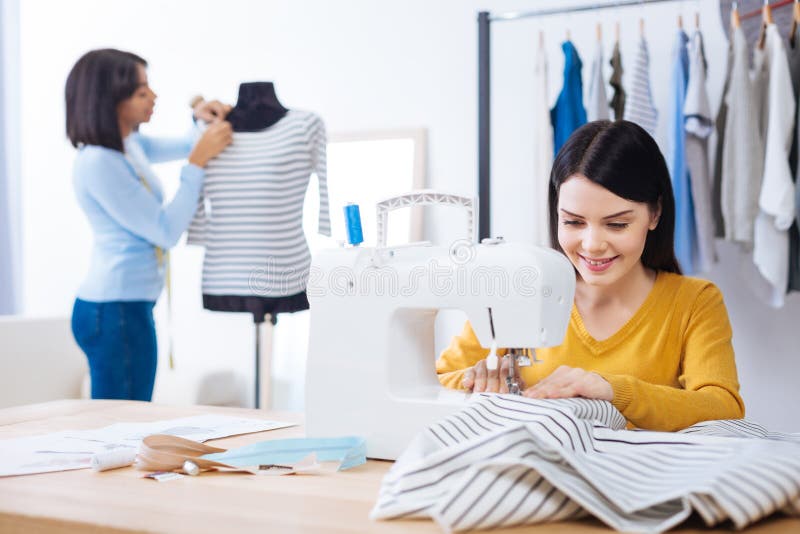 Two Young Colleagues Smiling while Doing Their Work Stock Photo - Image ...