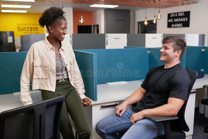 Two Young College Students Relax in the Library, Talking and Chatting ...