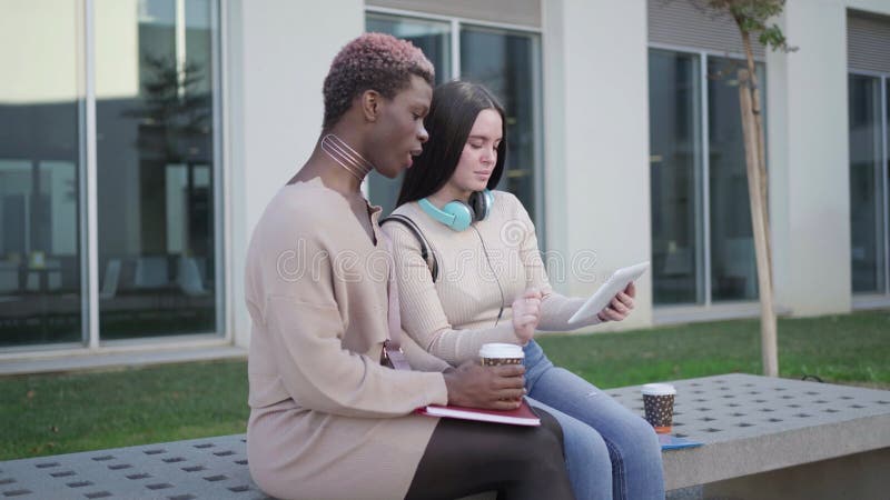 Two Young College Students Review Notes on the Tablet Sitting on the ...