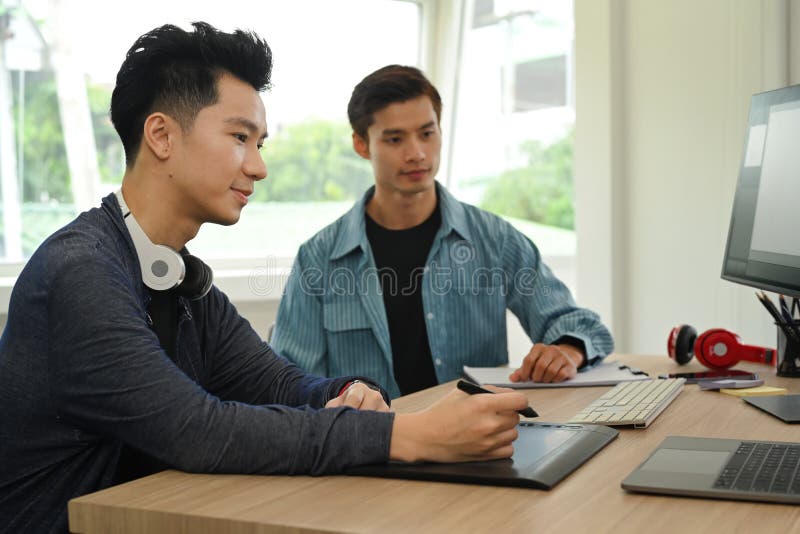 Two Young Content Creator Working Together, Editing Video Footage with ...