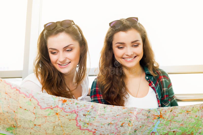 Two Young Dark-haired Girl Looking at the Map Stock Photo - Image of ...
