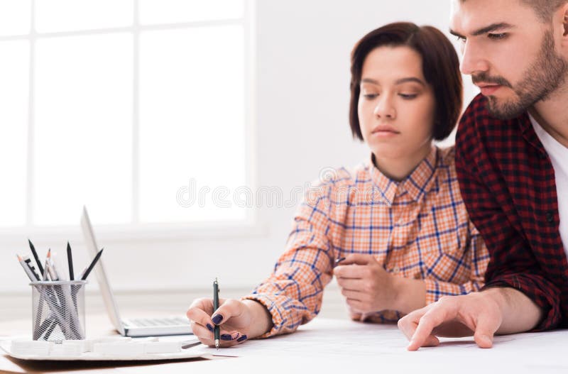Two Young Designers Working on Project Together. Stock Image - Image of ...
