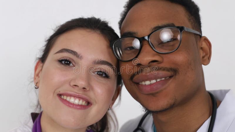 Two Young Doctors of Different Races Looking and Smiling Stock Video ...