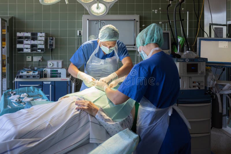 2 Young Doctors Perform an Operation in an Operating Theatre Editorial ...