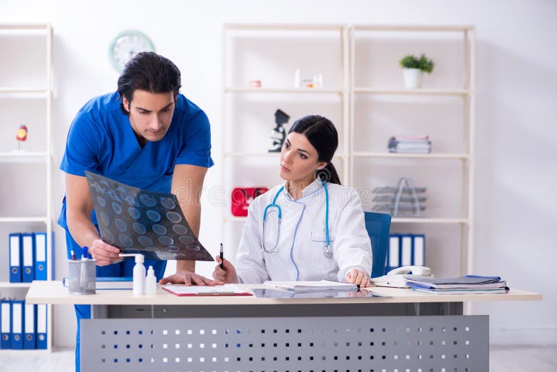 The Two Young Doctors Working in the Clinic Stock Photo - Image of ...
