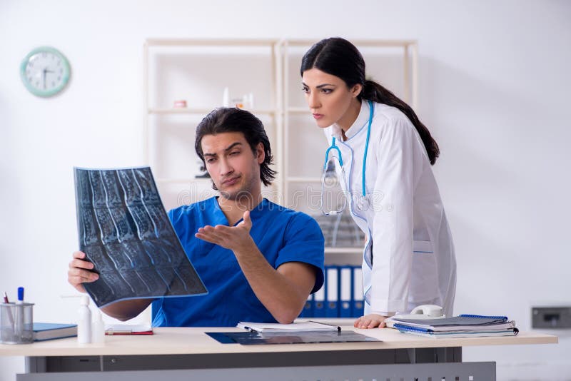 The Two Young Doctors Working in the Clinic Stock Image - Image of ...
