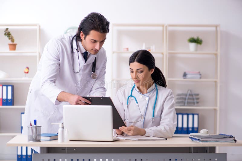 Two Young Doctors Working in the Clinic Stock Photo - Image of ...