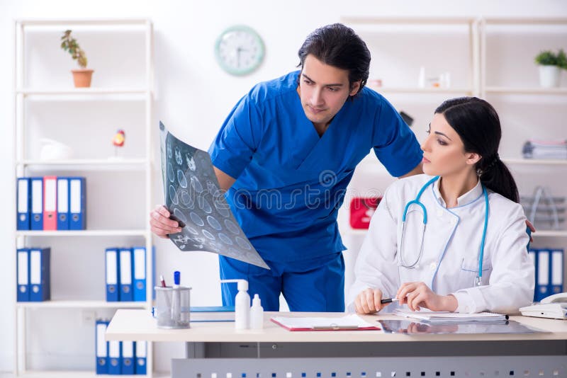 Two Young Doctors Working in the Clinic Stock Image - Image of recovery ...
