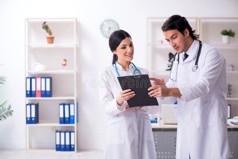 Two Young Doctors Working in the Clinic Stock Photo - Image of ...
