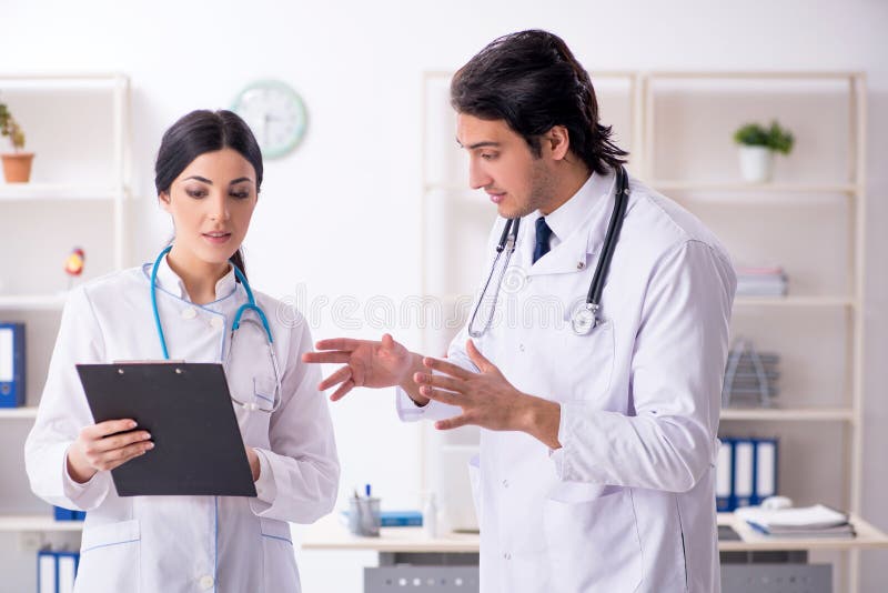 Two Young Doctors Working in the Clinic Stock Image - Image of clinic ...