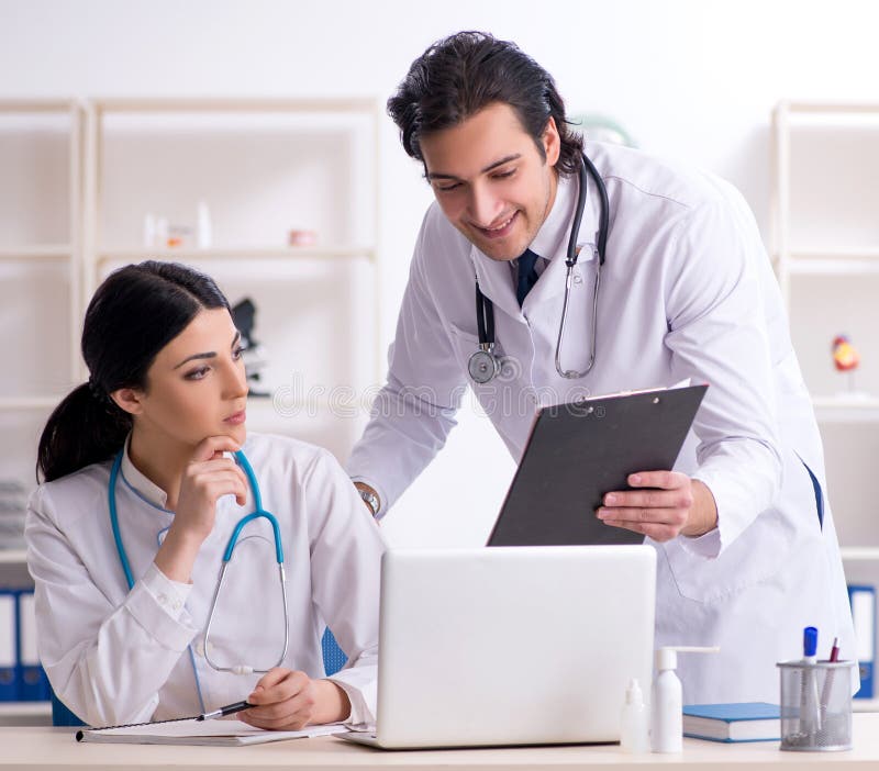 Two Young Doctors Working in the Clinic Stock Image - Image of ...