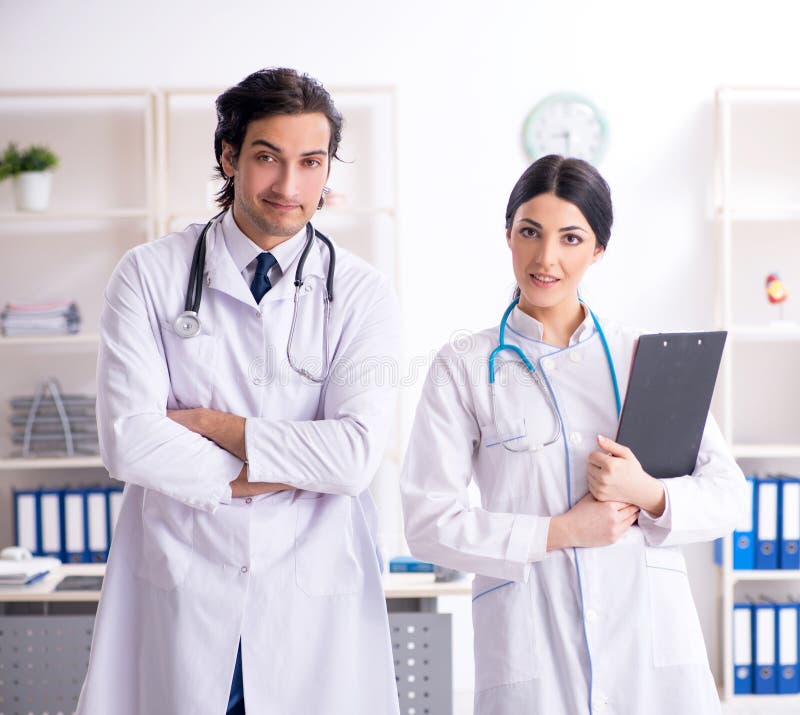 Two Young Doctors Working in the Clinic Stock Photo - Image of ...