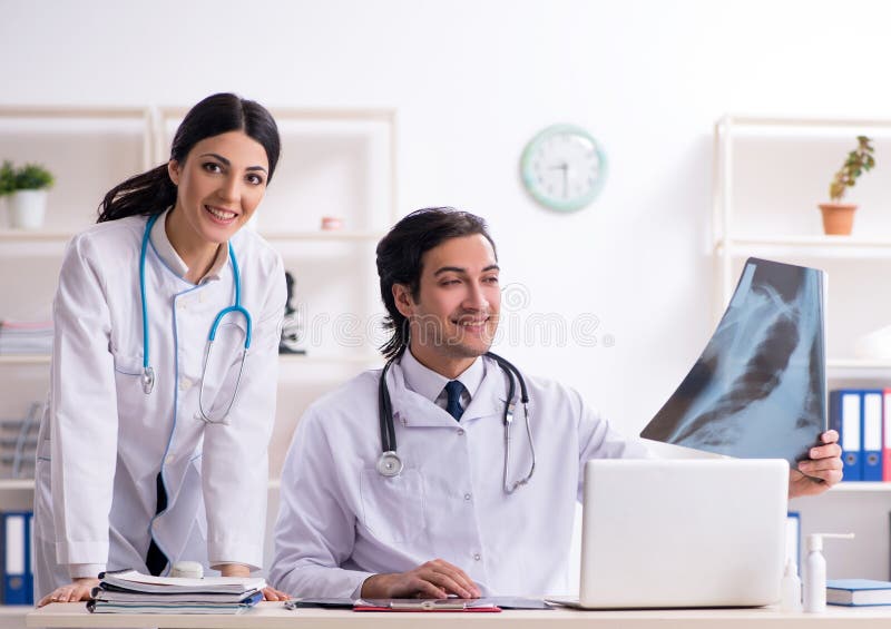 Two Young Doctors Working in the Clinic Stock Photo - Image of hospital ...