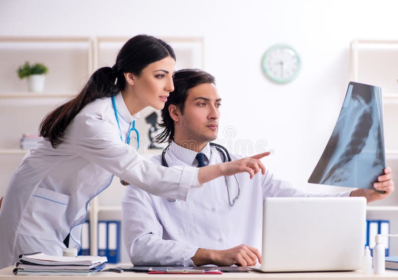 Two Young Doctors Working in the Clinic Stock Image - Image of care ...