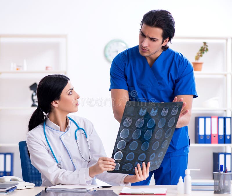 Two Young Doctors Working in the Clinic Stock Image - Image of ...