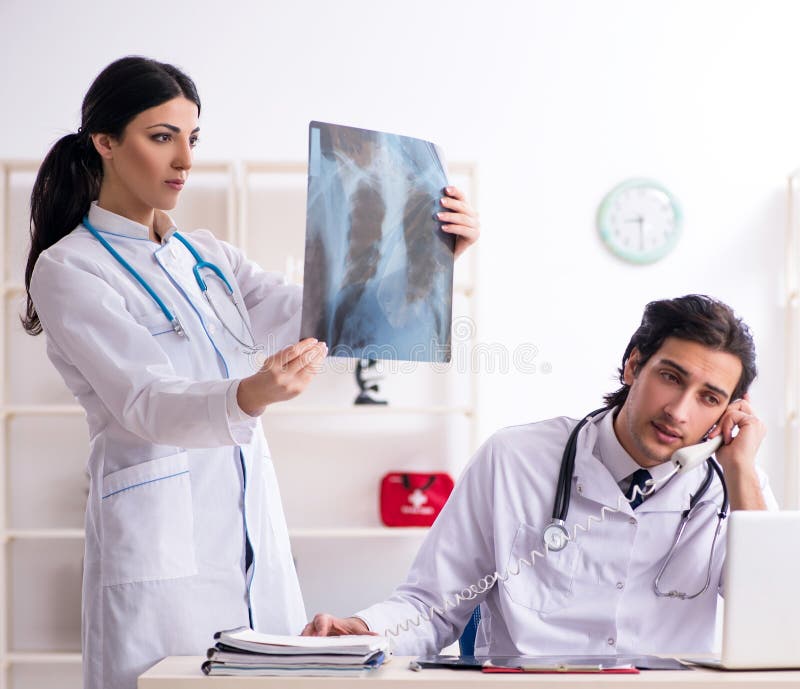 Two Young Doctors Working in the Clinic Stock Image - Image of ...