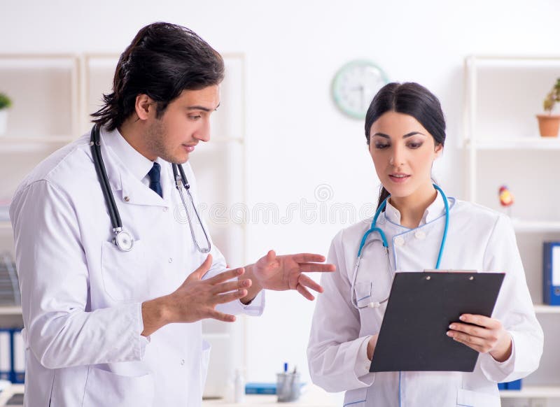 Two Young Doctors Working in the Clinic Stock Image - Image of ...