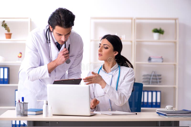 The Two Young Doctors Working in the Clinic Stock Image - Image of ...