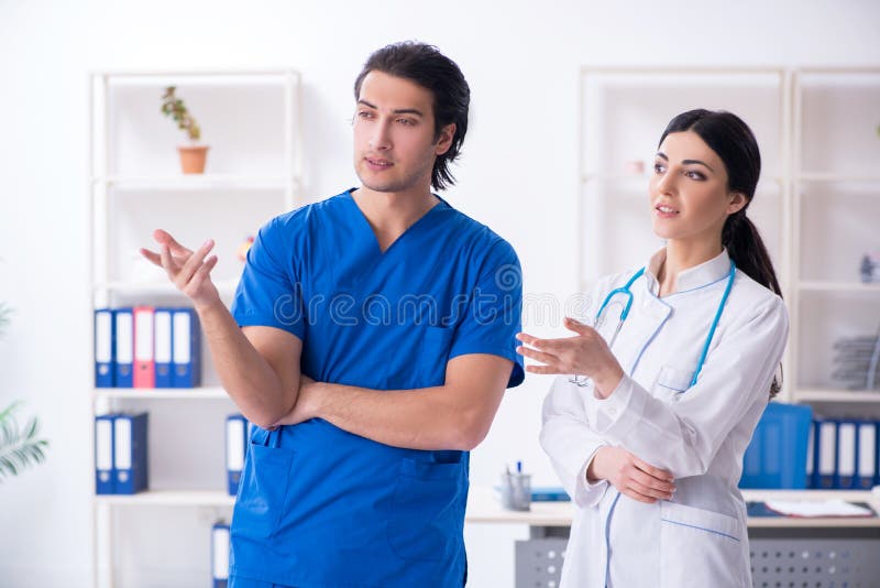 The Two Young Doctors Working in the Clinic Stock Photo - Image of ...
