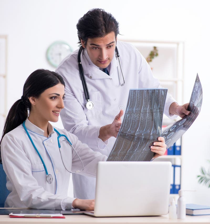 Two Young Doctors Working in the Clinic Stock Image - Image of doctor ...