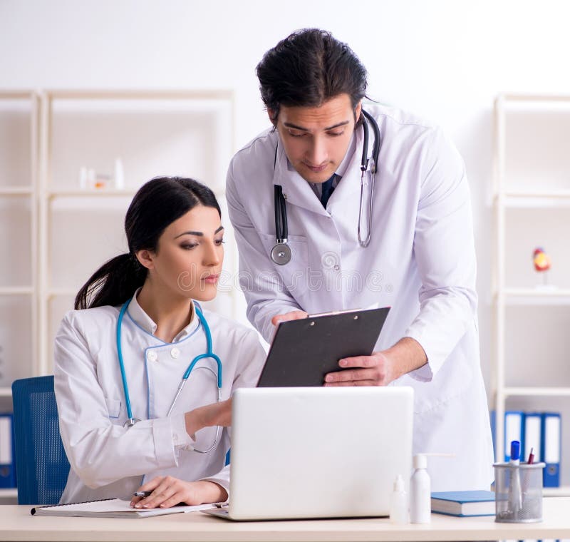 Two Young Doctors Working in the Clinic Stock Image - Image of medic ...