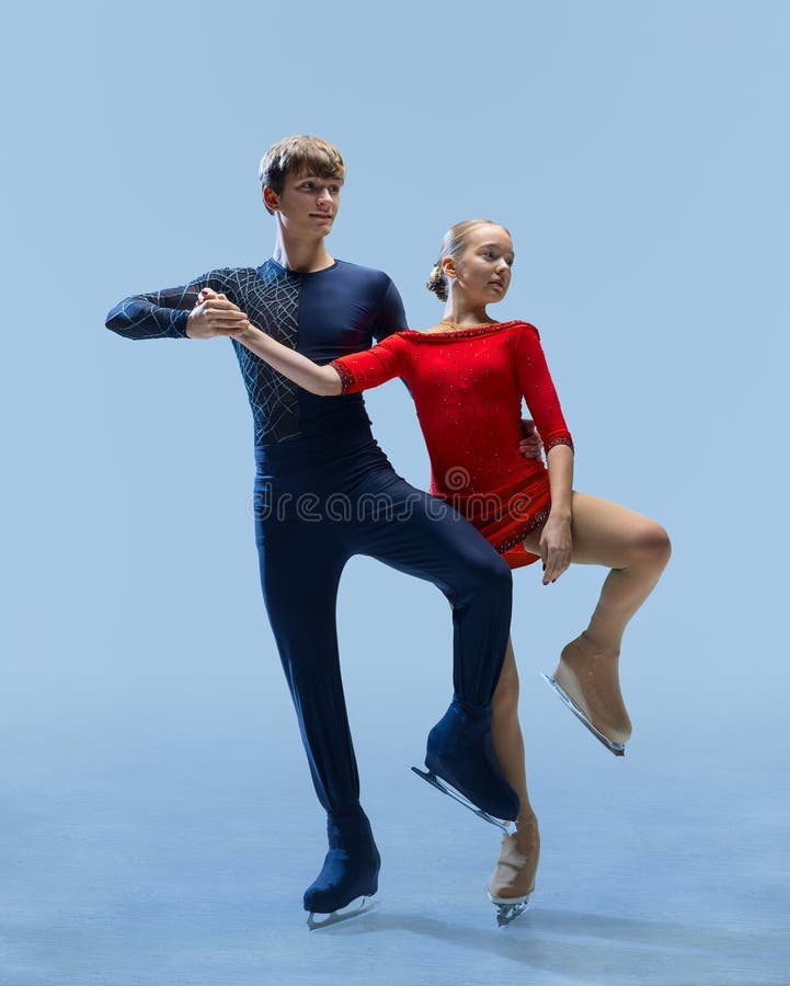 Two Young, Elegant Figure Skaters in Perfect Sync, Executing Complex ...
