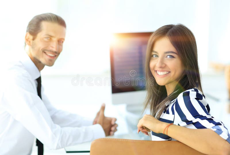 Two Young Employee Sitting Behind a Desk Stock Photo - Image of indoor ...